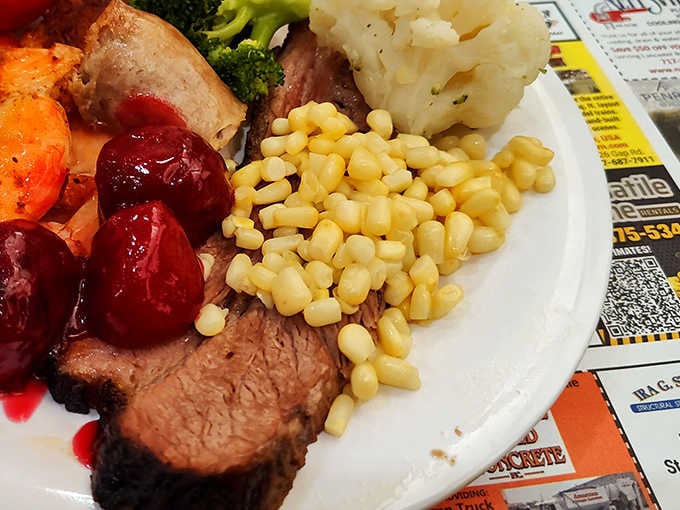 Comfort on a plate: tender brisket swimming in rich gravy alongside buttery mashed potatoes and sweet corn that pops with freshness.