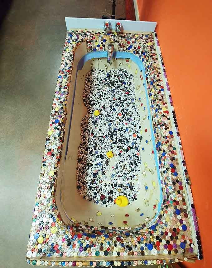Yes, that's a bathtub filled with buttons, because apparently every surface deserves the decorative treatment here.