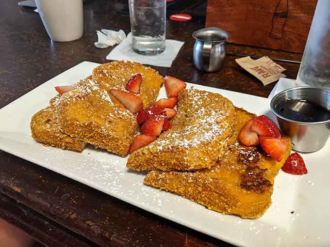 Cornflake-crusted French toast dusted with powdered sugar and crowned with strawberries is pure breakfast genius in action.