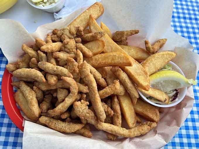 Golden clam strips and fries piled high enough to feed a small army or one very determined coastal visitor.