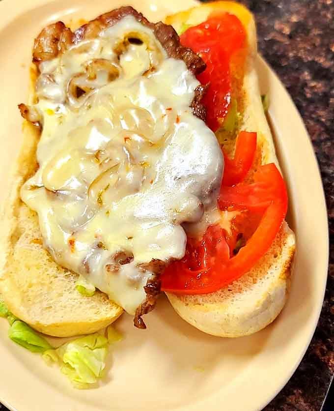 When a ribeye sandwich gets this much cheese and grilled onions, everyone wins at lunch.