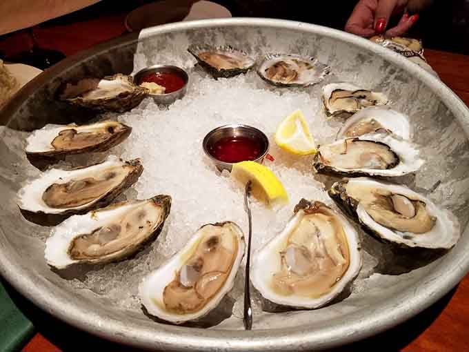 A dozen oysters on ice, nature's perfect appetizer that makes you feel fancy without even trying too hard.