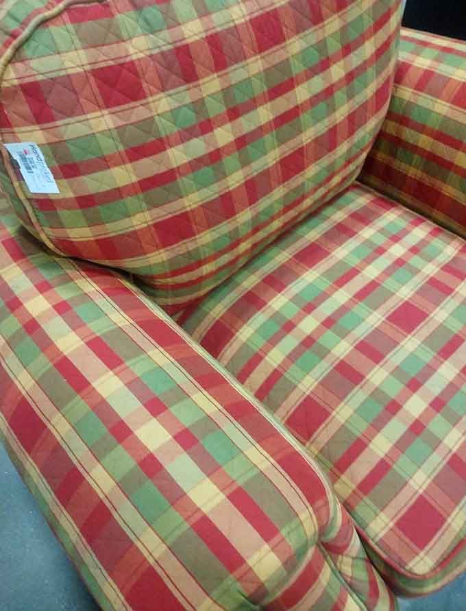 A plaid couch that screams "Vermont cabin chic" or perhaps "1990s nostalgia"—either way, it's conversation piece that costs less than dinner for two.