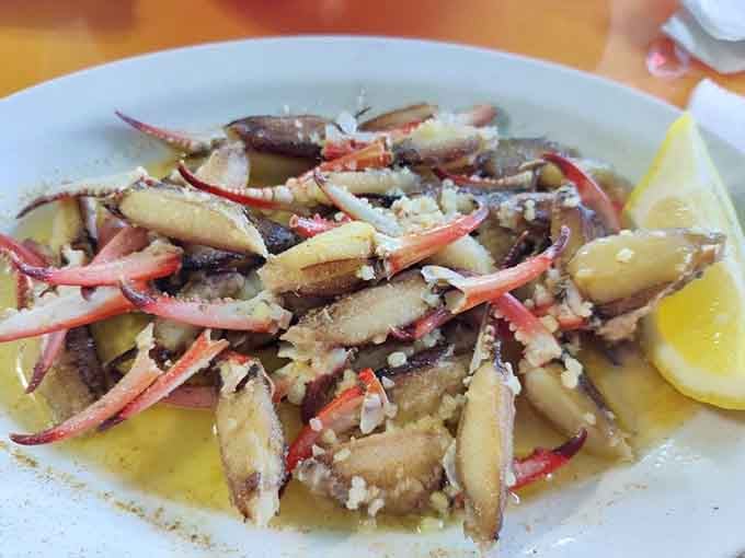 Crab legs piled high with garlic butter pooling beneath them, this is what seafood dreams look like.
