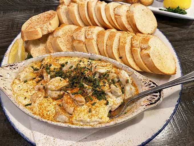 Dive into this creamy crab dip that's practically begging for those toasted baguette slices to take a swim. Pure indulgence!