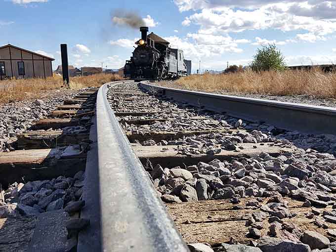 The narrow-gauge tracks stretch toward distant mountains, looking deceptively fragile for the heavy work they've performed for over a century.