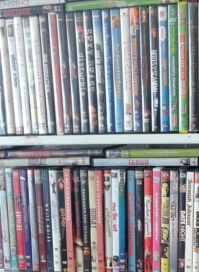 Cinema history lines these shelves, from forgotten rom-coms to cult classics&mdash;each DVD a portal to someone's movie night memories.