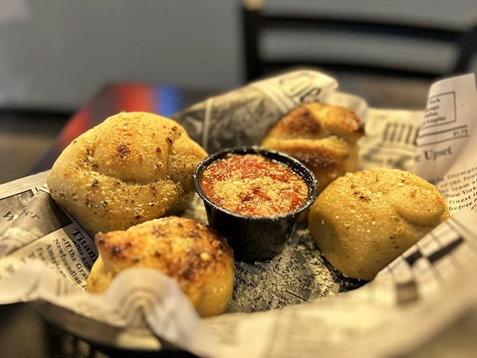 Golden garlic knots arrive with marinara for dipping, because some traditions are worth keeping forever.