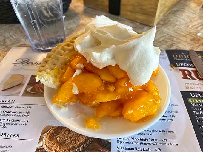 Peach pie topped with whipped cream and a side of waffles, because apparently someone in the kitchen understands pure joy.