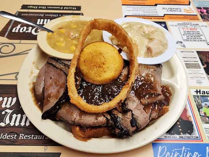 Tender roast beef piled high with caramelized onions and a side of cornbread that could make a grown person emotional.