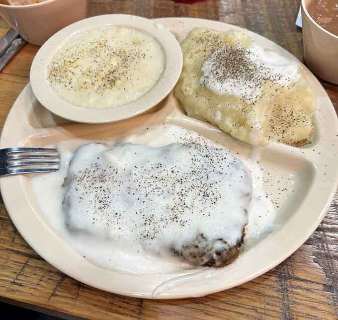 Country fried steak swimming in white gravy, the kind of breakfast that turns morning people into believers.