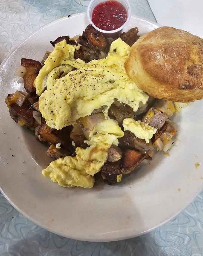 The Scram Bowl Platter piles scrambled eggs over crispy potatoes with a biscuit that'll make your heart sing.