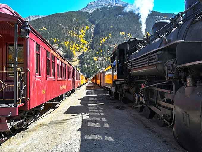 That plume of steam against mountain peaks is basically Colorado's version of a Renaissance painting.