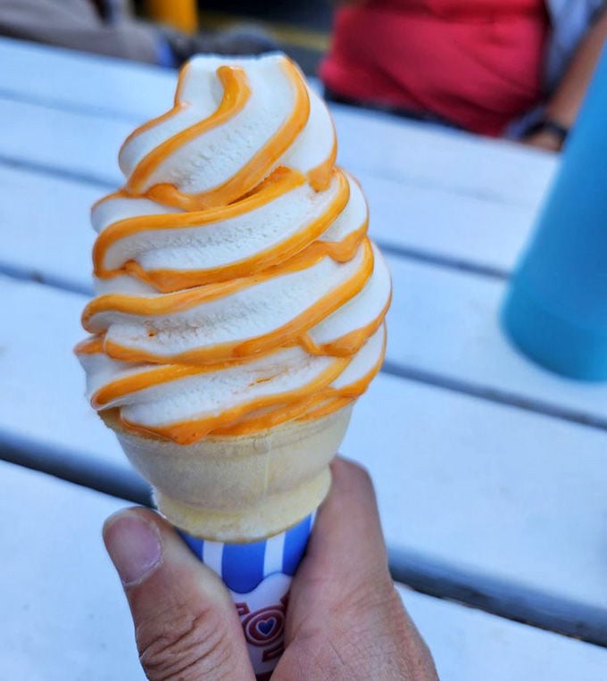 That caramel drizzle spiraling down creamy soft-serve looks like edible art you'll devour in three minutes flat.