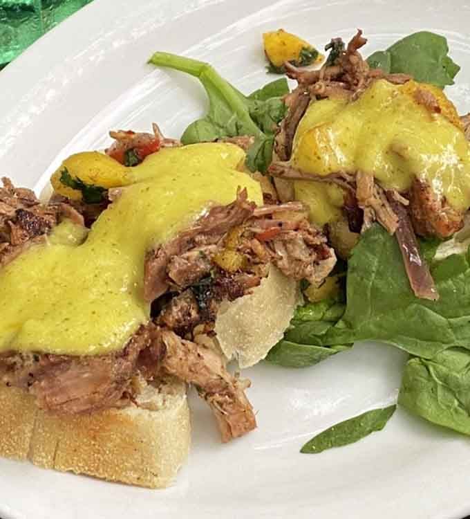 Tender pork topped with bright sauce demonstrates why tapas dining beats boring single-entree meals every single time.