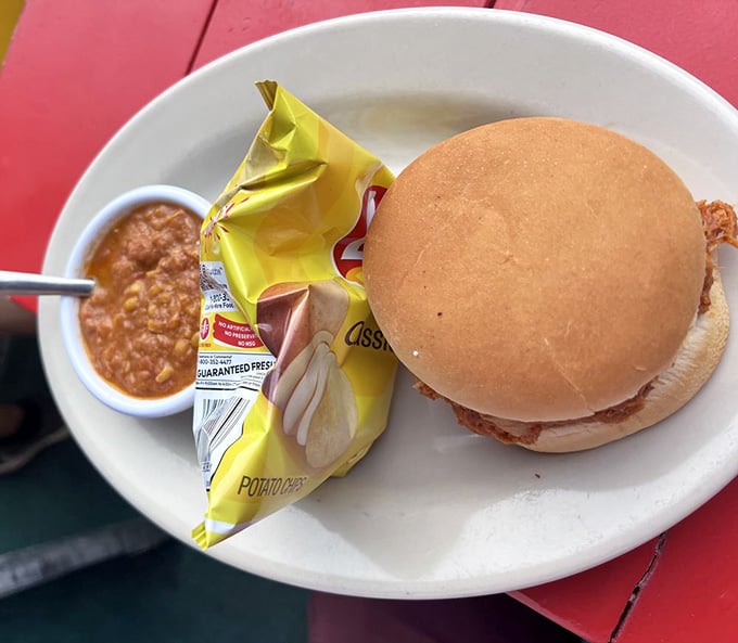 That chopped pork sandwich comes with chips because even simple pleasures deserve good company at the table.