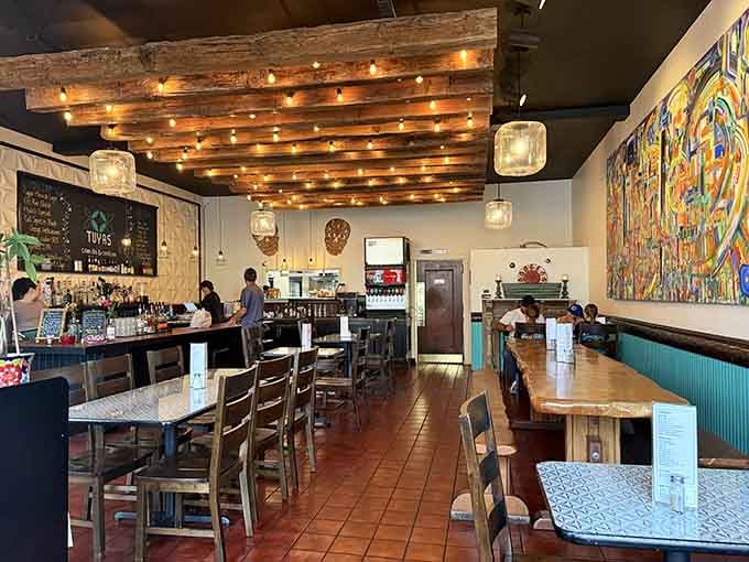 Cozy dining spaces where exposed beams and string lights create ambiance that Instagram filters try desperately to replicate.