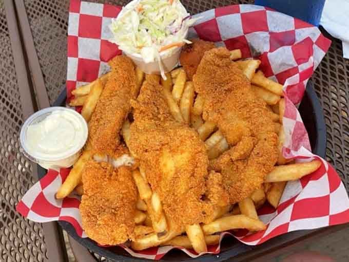 Golden fried catfish and fries served in a checkered basket, because some traditions are too good to mess with.