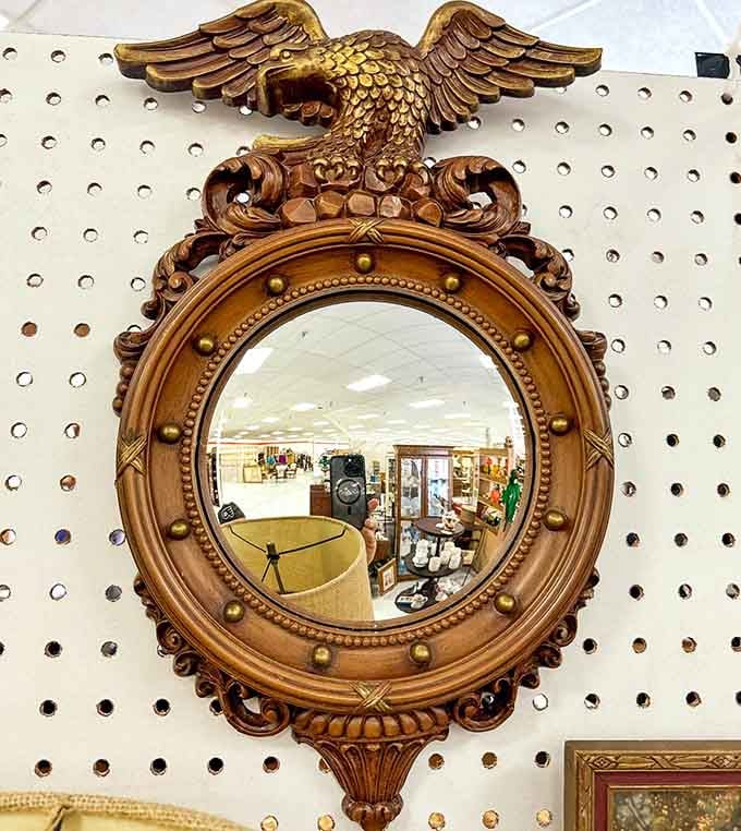 An eagle-topped mirror reflecting decades of style, because apparently our ancestors understood dramatic home decor perfectly.