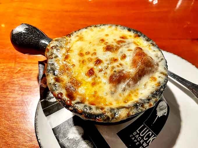 Bubbling cheese, rich broth, and a perfectly toasted crown &ndash; this French onion soup isn't just comfort food, it's a warm hug in a ceramic crock.