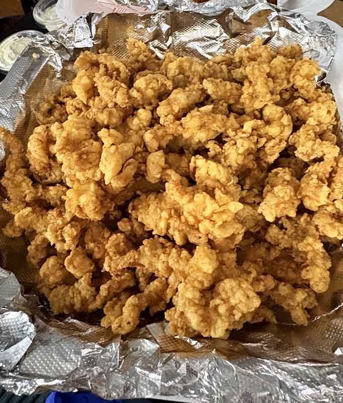A mountain of fried clams that would make any New England seafood lover weep tears of joy and reach for extra napkins.