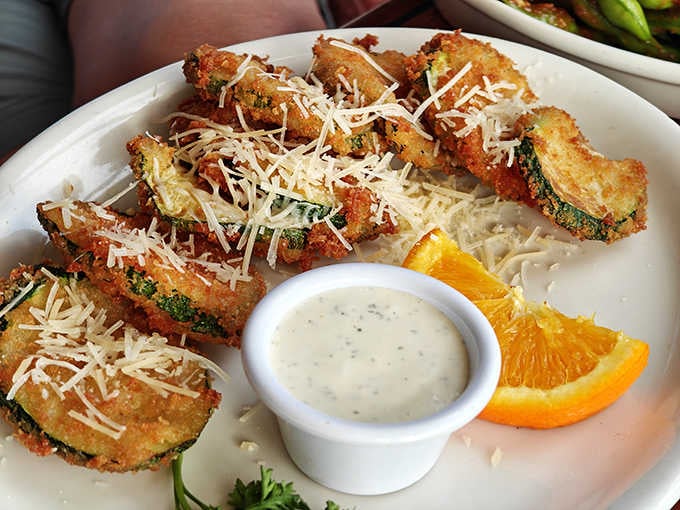 The golden crunch of these fried green tomatoes could make even the most dedicated health guru temporarily abandon their principles. That dipping sauce? Pure creamy genius.