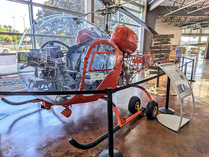 The Bell 47 helicopter sits transparent and exposed, revealing mechanical secrets usually hidden from view.