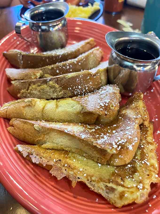 French toast dusted with powdered sugar and served with syrup, because some mornings demand pure indulgence.