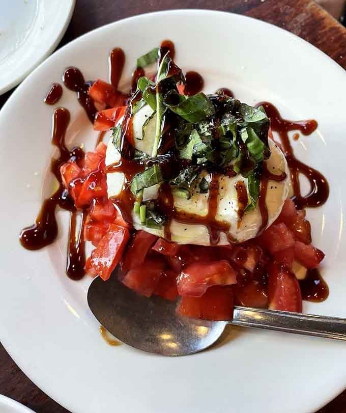 Fresh mozzarella stacked with tomatoes and basil, drizzled with balsamic. Simple ingredients, extraordinary results. Italy approves.