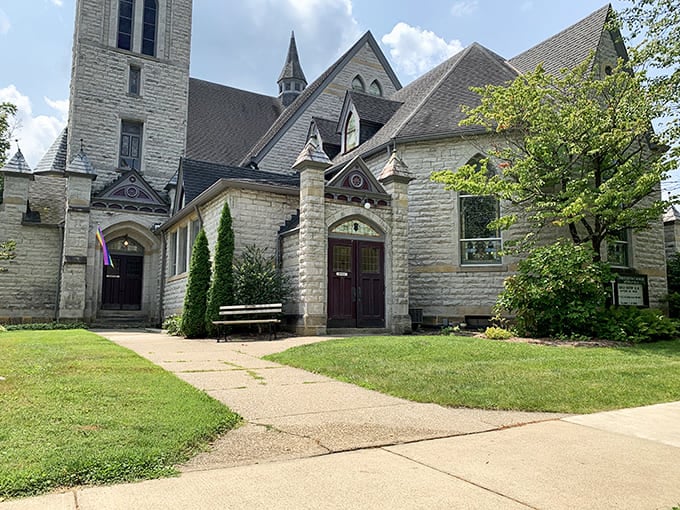 This Gothic stone church looks like it teleported straight from a New England village, steeple and all, without asking permission first.