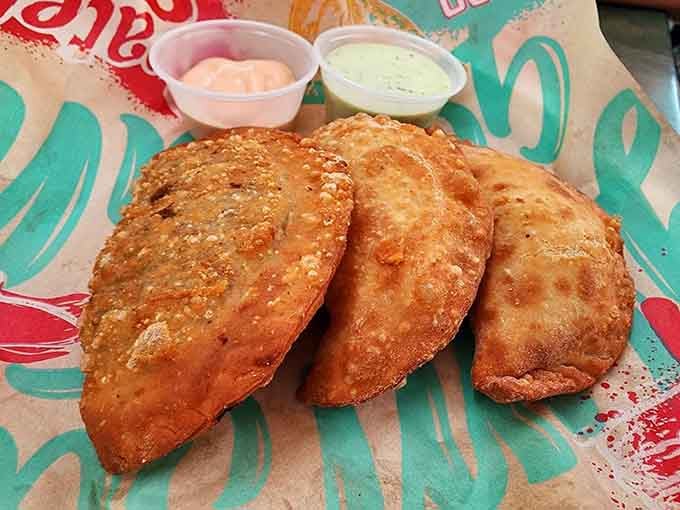 Golden empanadas arrive with two dipping sauces because one would be uncivilized and frankly insufficient.