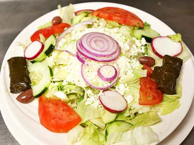 A Greek salad that brings Mediterranean sunshine to Long Island &ndash; crisp, colorful, and adorned with those purple rings of onion bliss.
