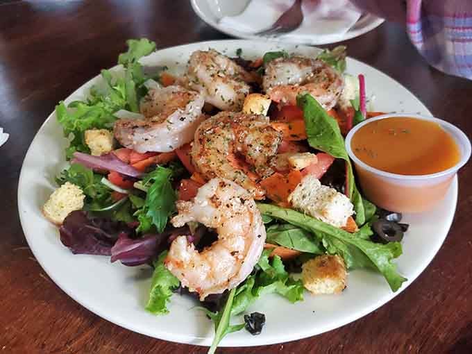 Plump grilled shrimp perched atop fresh greens prove even dive bars understand the meaning of balance and variety.