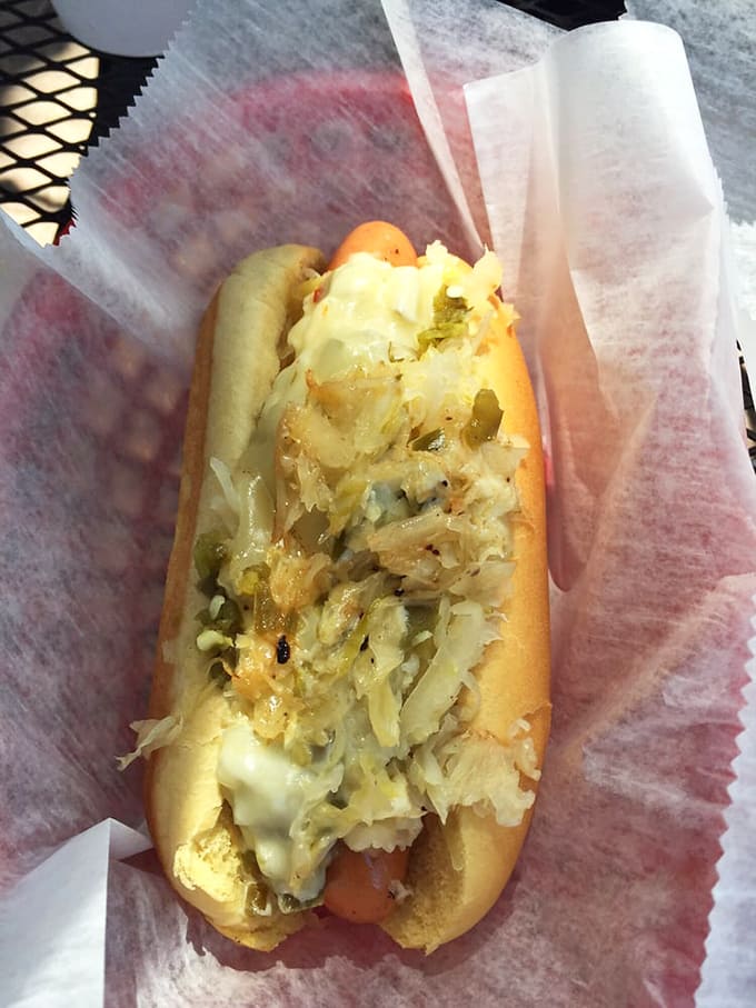 A hot dog elevated to art form. That sauerkraut and melted cheese combo is what dreams are made of.