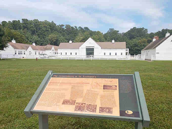 White farm buildings and interpretive signs ready to share centuries of agricultural heritage with anyone curious enough to explore.