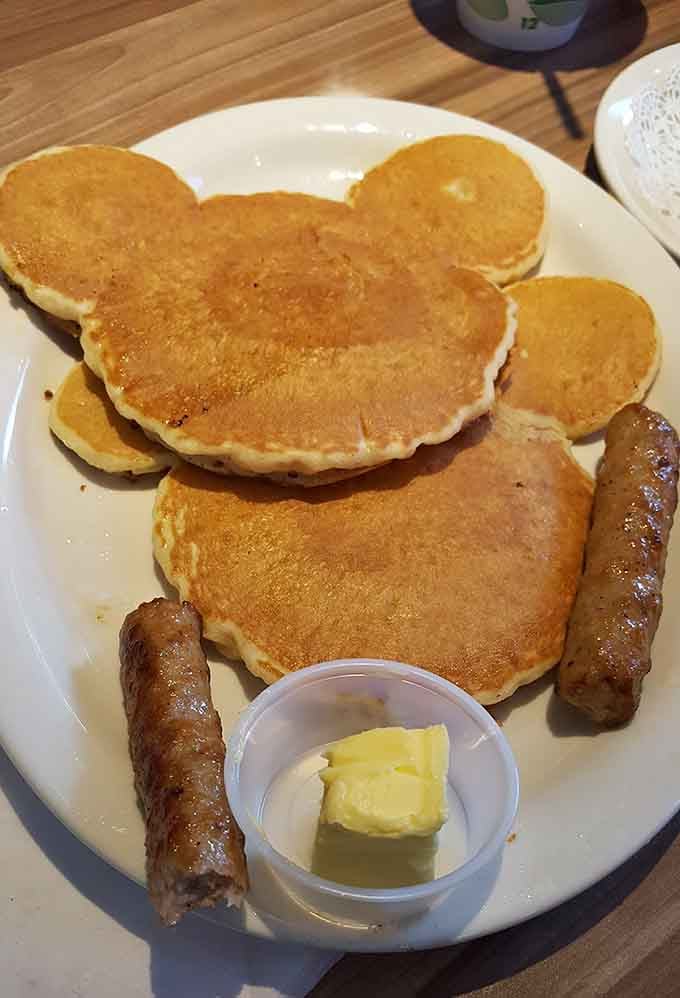 Mickey Mouse pancakes proving that childhood joy and adult breakfast can absolutely coexist on the same plate.