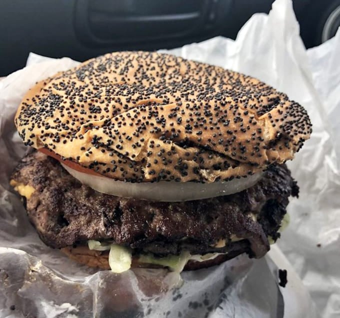 A burger topped with a poppy seed bun because sometimes classic American comfort food needs a little pizzazz.