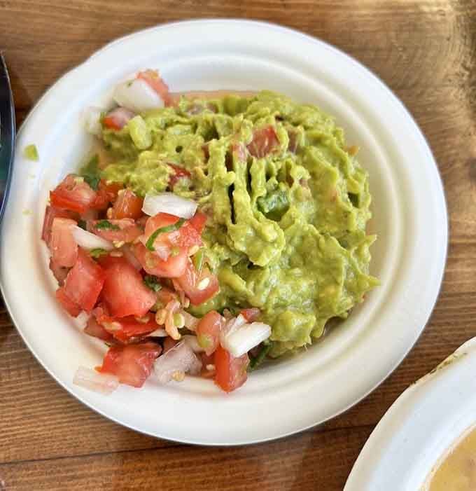 Creamy guacamole topped with fresh pico de gallo, because sometimes simple perfection needs no introduction.