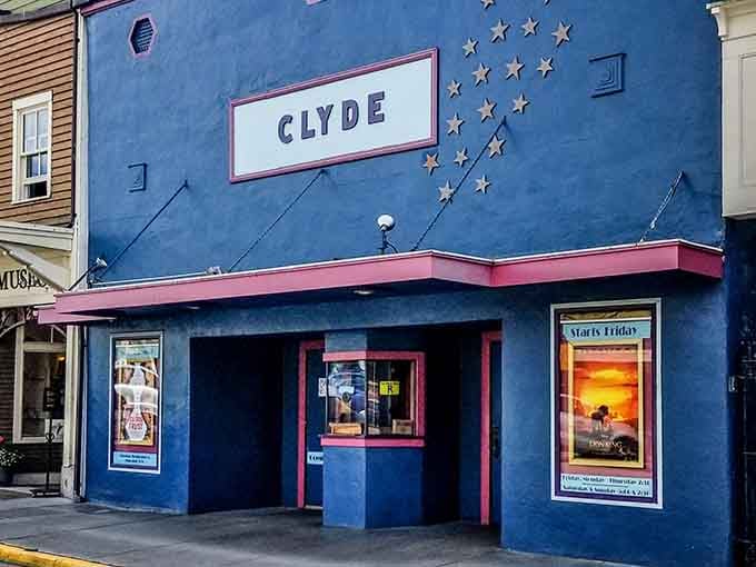 The Clyde Theatre's vintage facade stands proud in blue, showing movies the way they were meant to be seen.