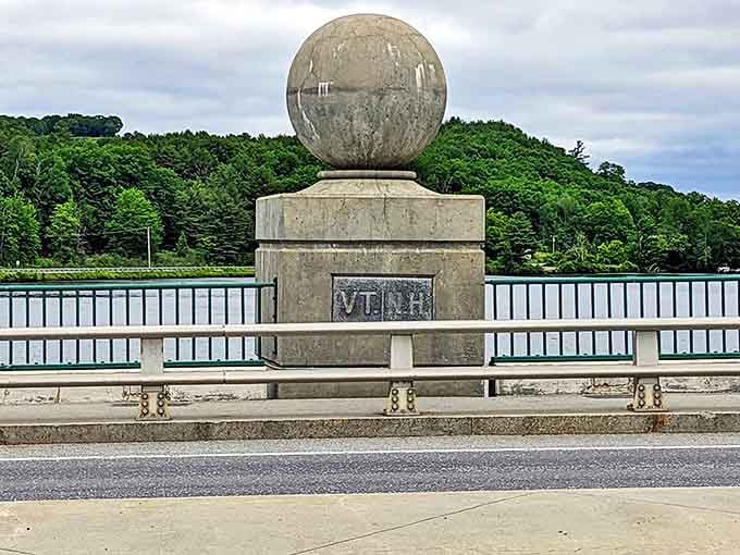 This bridge marker stands sentinel between New Hampshire and Vermont. Cross-state diplomacy in stone and concrete, no passport required.