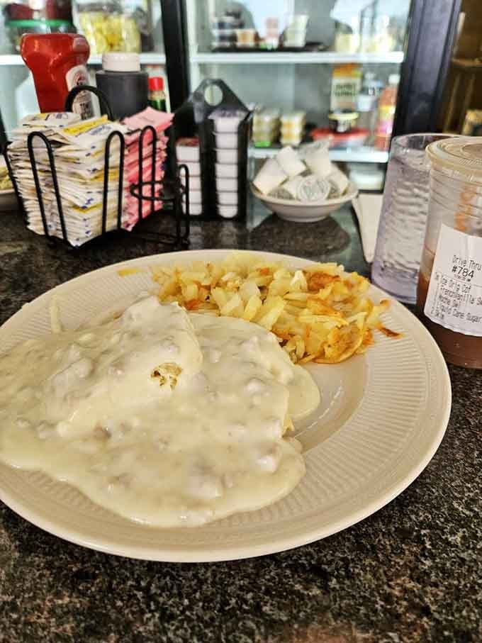 Sausage gravy cascading over biscuits like a delicious avalanche, proving comfort food never goes out of style.