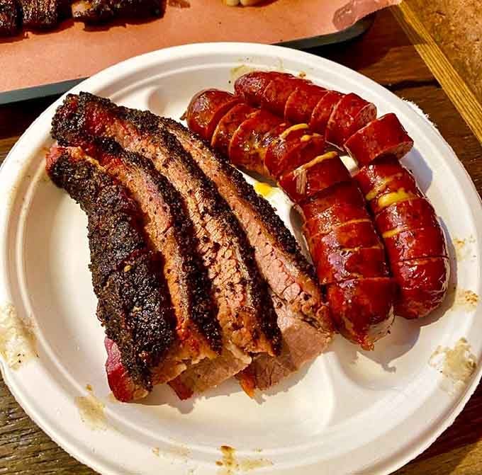 Sliced brisket and sausage links demonstrate the art of low and slow smoking done absolutely right.