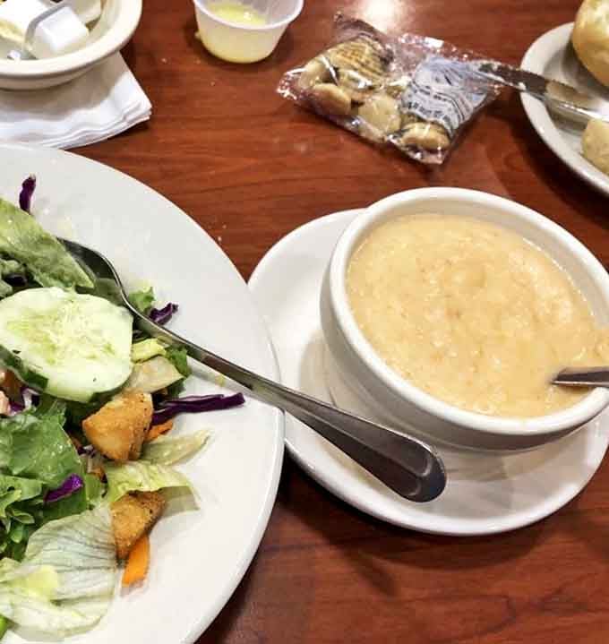 A bowl of creamy soup alongside a fresh salad&mdash;the diner's version of balance. One spoonful and winter suddenly feels miles away.