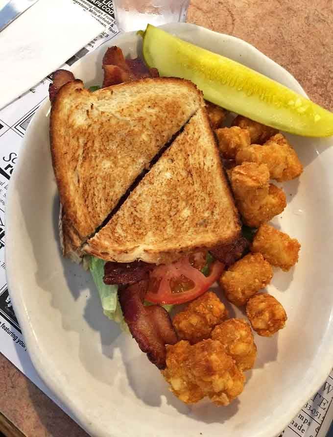 A proper BLT with tater tots and a pickle spear is comfort food's way of giving you a hug at lunchtime.