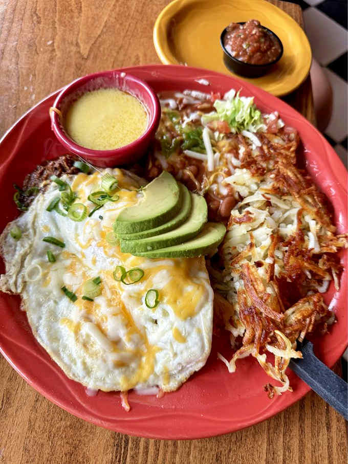 Eggs with avocado slices and perfectly crispy hash browns, proving breakfast can be both beautiful and substantial.
