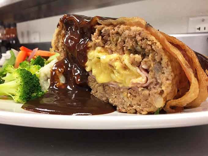 Behold the stuffed meatloaf&mdash;a savory masterpiece with cheese oozing from its center like molten treasure. Comfort food engineering at its finest.