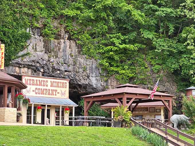 The picnic area sits nestled against the cliff, offering a peaceful spot with views of the cave entrance.