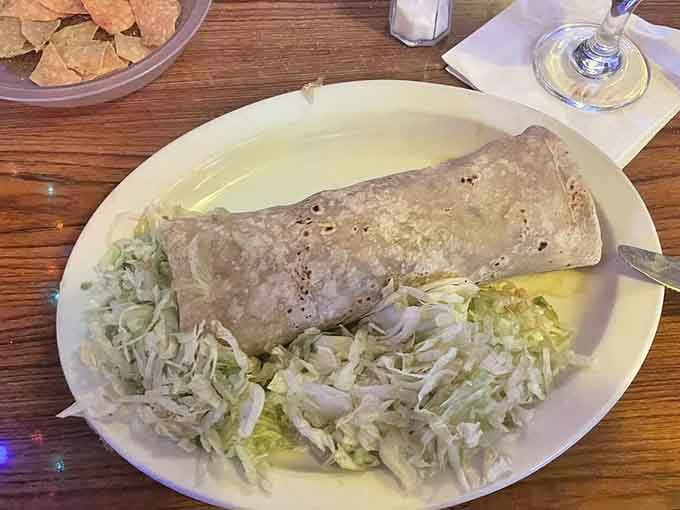 This green chile beef burrito arrives like a delicious torpedo of flavor, ready to make your taste buds very happy.