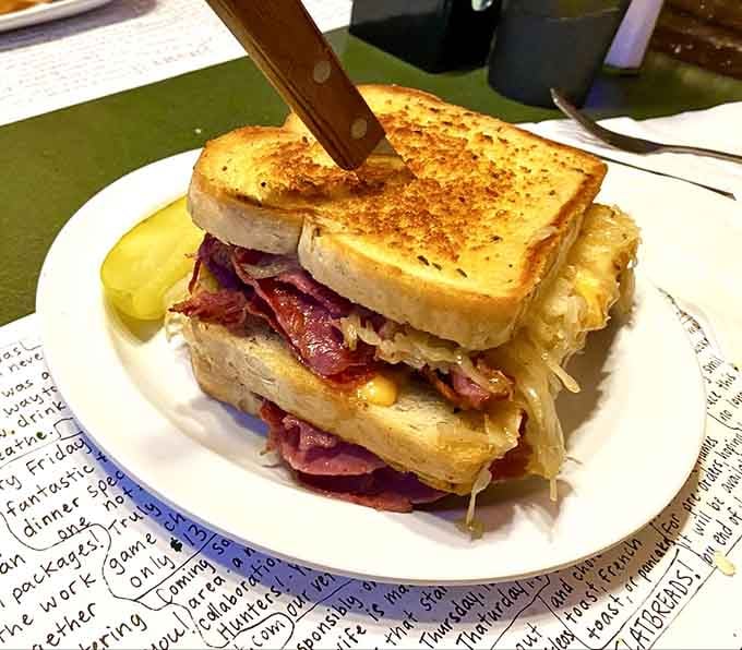 This Reuben stands tall with corned beef, sauerkraut, and enough cheese to make your cardiologist schedule a meeting.