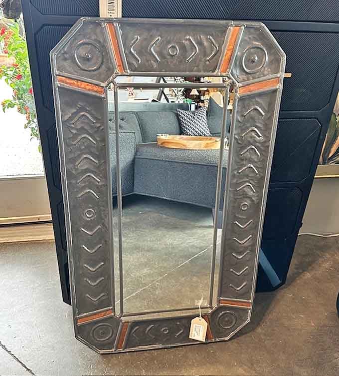 A mirror with enough character to start its own podcast. Those metallic accents tell stories of cocktail parties past.